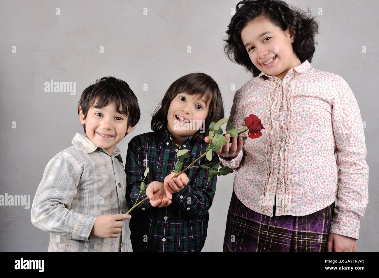 Beautiful kids with red rose Stock Photo - Alamy