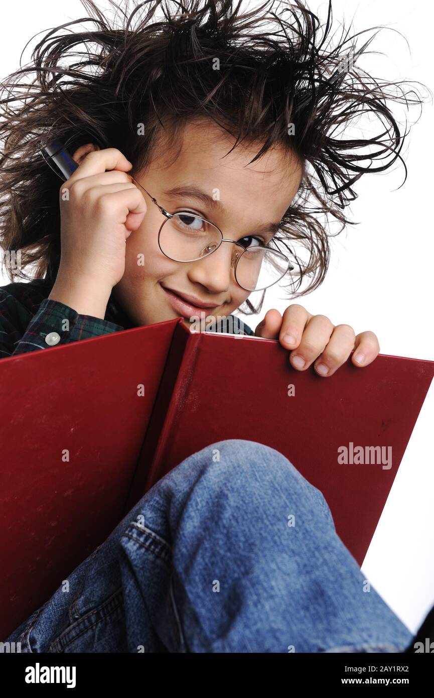 Smart nerd kid with glasses and funny hair writing Stock Photo - Alamy
