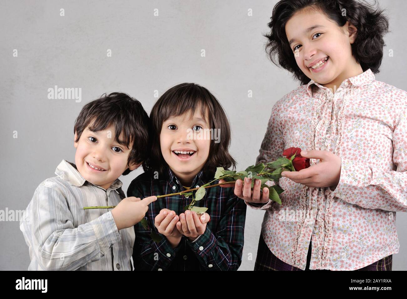 Happy smiling kids with red rose Stock Photo - Alamy