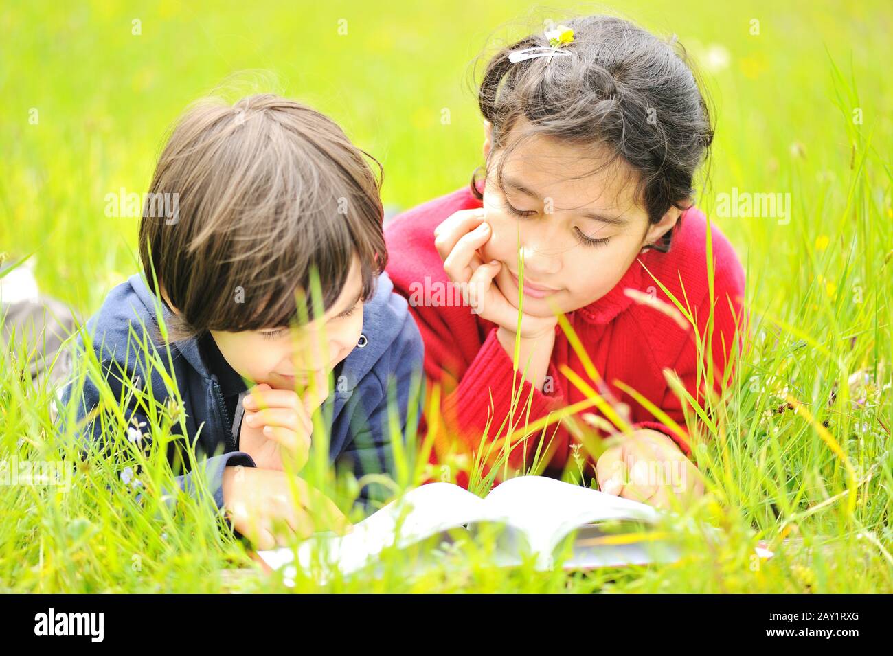 Happy children reading the book Stock Photo - Alamy