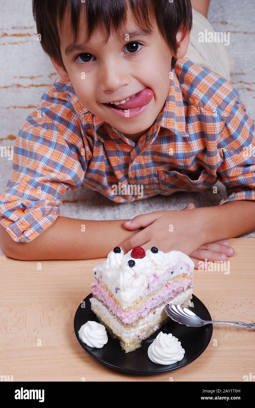 Very cute kid about to eat colorful cake Stock Photo - Alamy