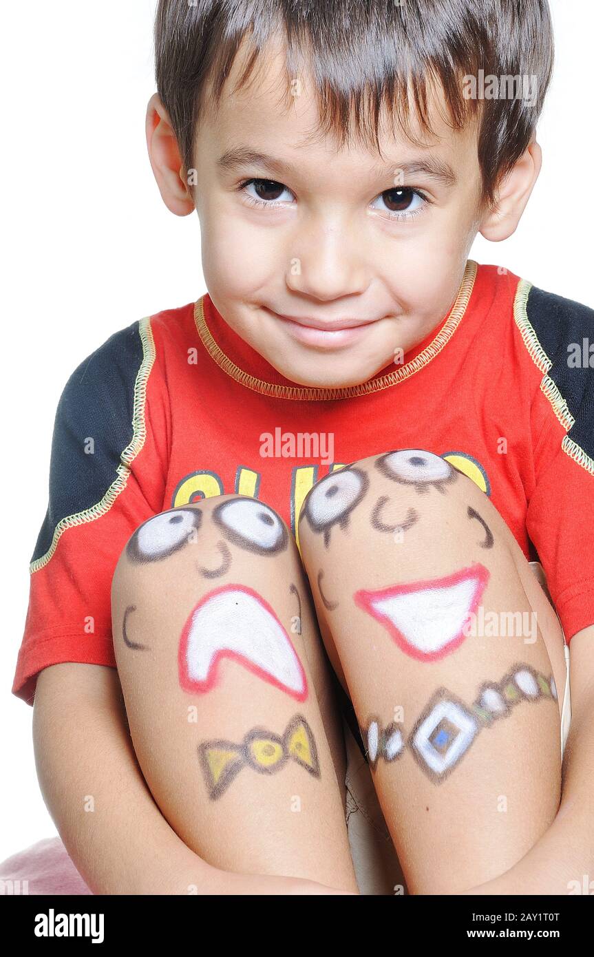 Cute kid with painting on legs Stock Photo - Alamy