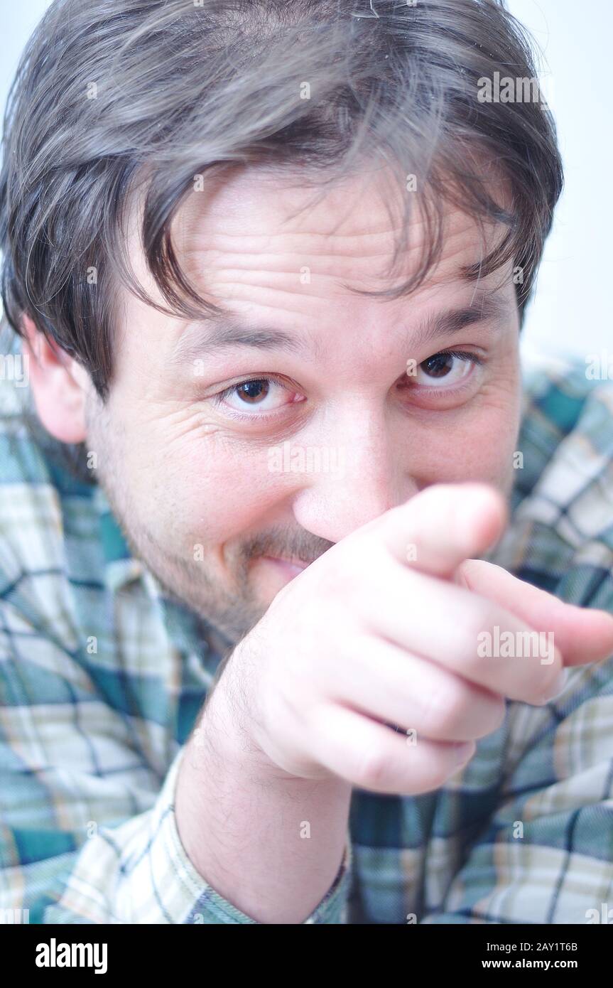 Young man with positive expression and finger pointing Stock Photo - Alamy