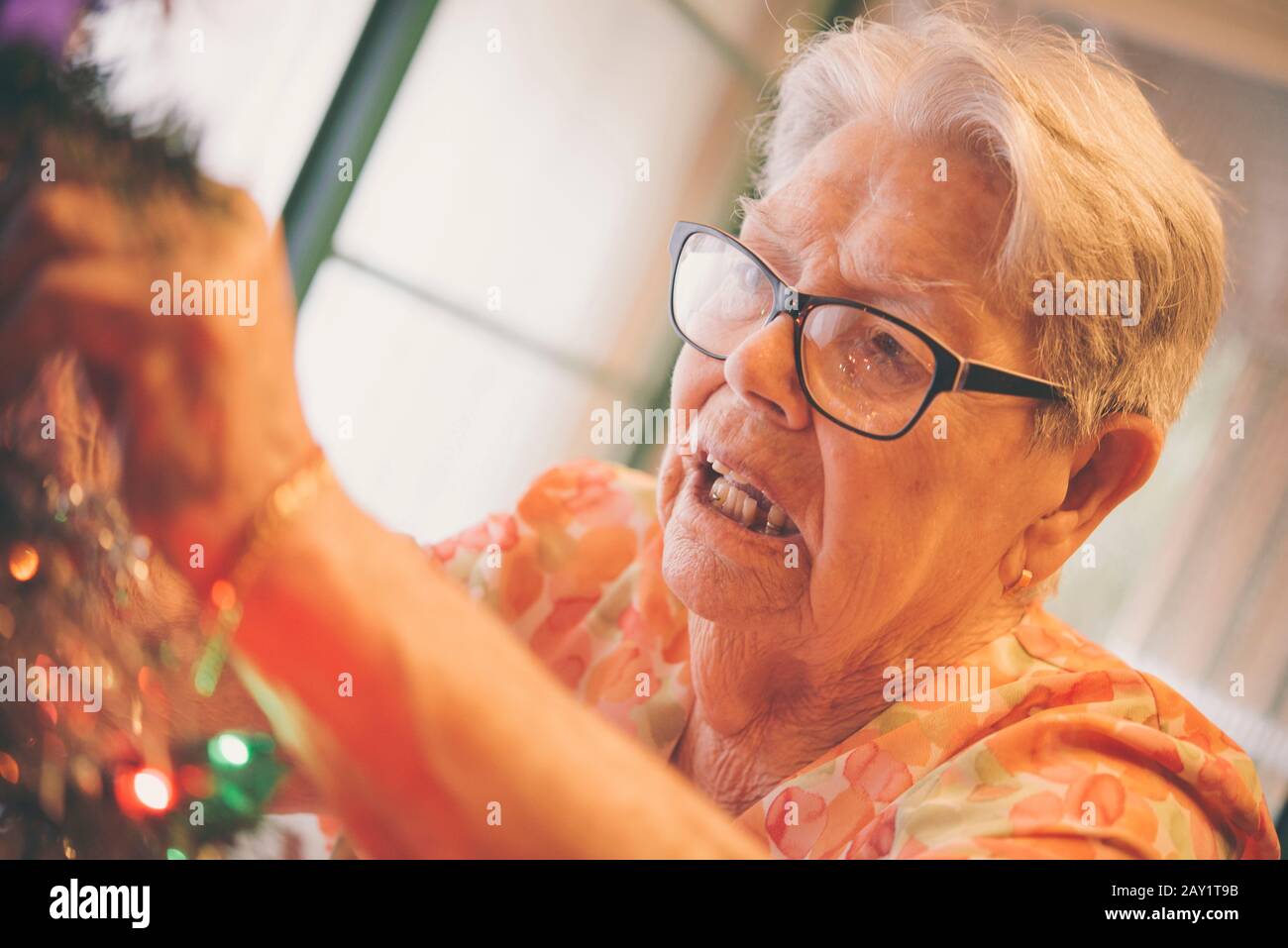 Woman decorating christmas tree candy hi-res stock photography and ...