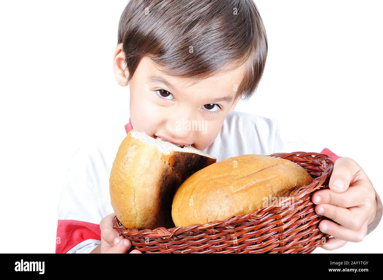 A little cute kid holding bread and biting Stock Photo - Alamy