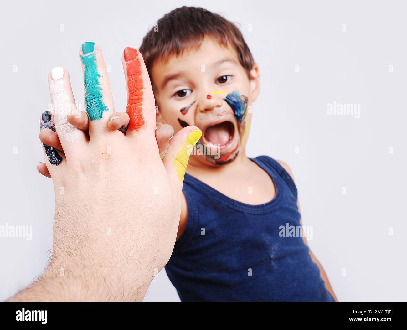 Little cute kid with colors on his face Stock Photo - Alamy