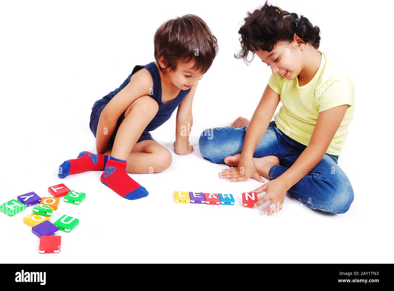 Children playing with cubes in white isolated space Stock Photo - Alamy