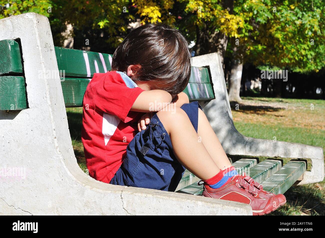 Sad child in the park Stock Photo - Alamy