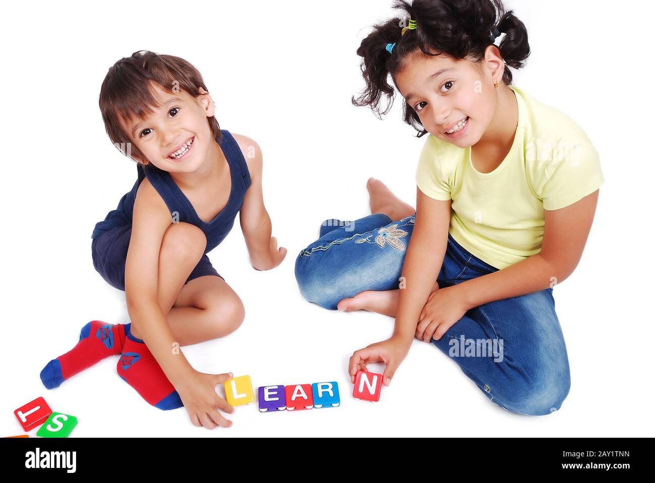 Children playing with cubes in white isolated space Stock Photo - Alamy