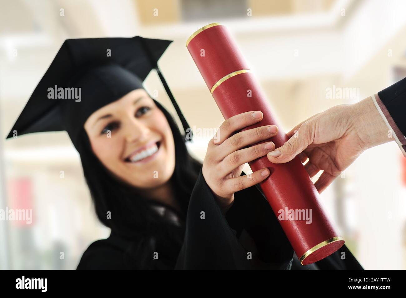Young female graduating and receiving diploma at university Stock Photo ...