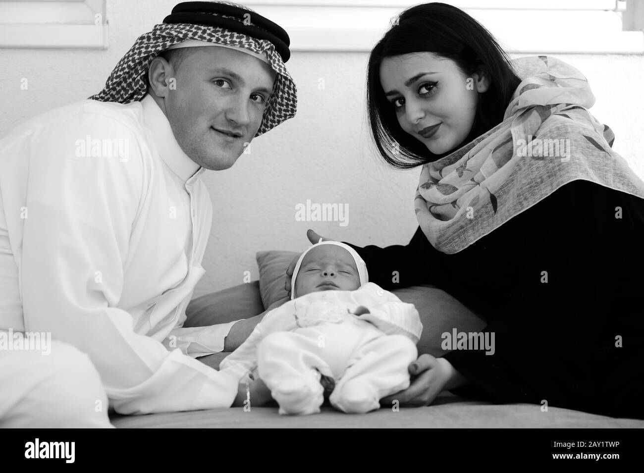 Arabic Muslim couple with new baby at home Stock Photo - Alamy