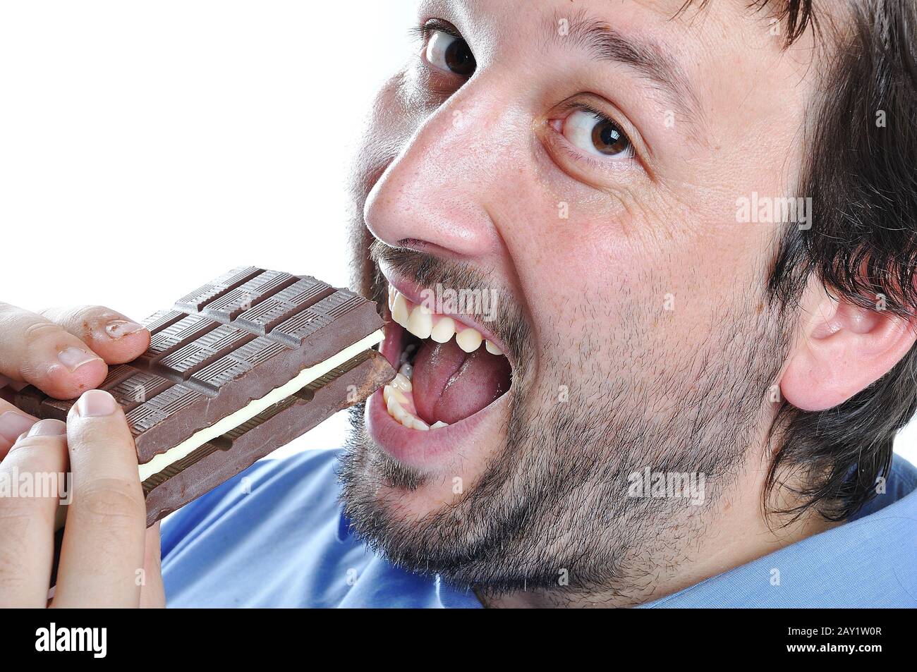 Young man eating sweet chocolate hi-res stock photography and images ...