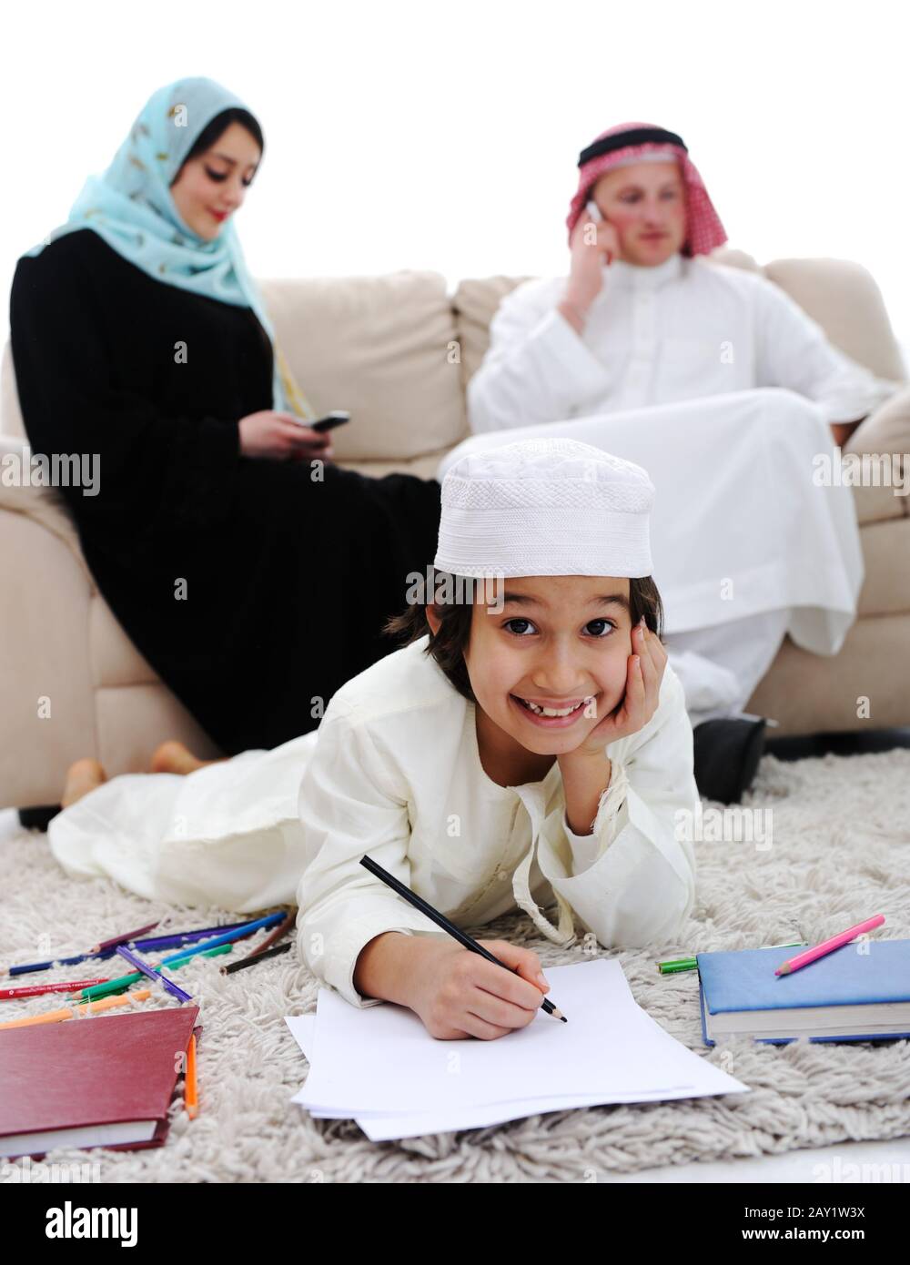 Happy child working on homework at home with his family Stock Photo - Alamy