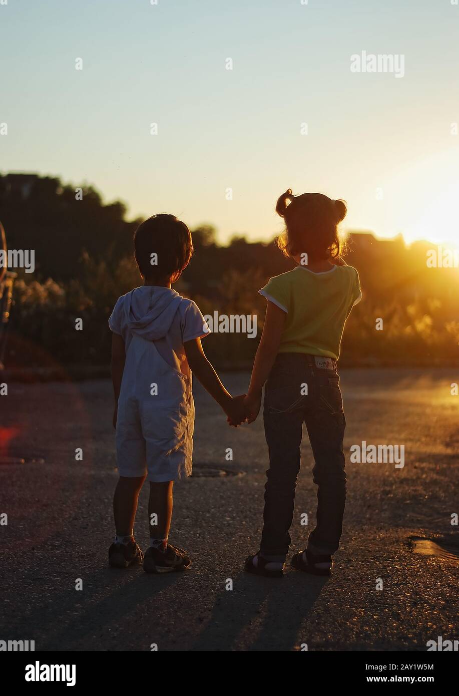 Romantic vision of two children standing together outdoor Stock Photo ...
