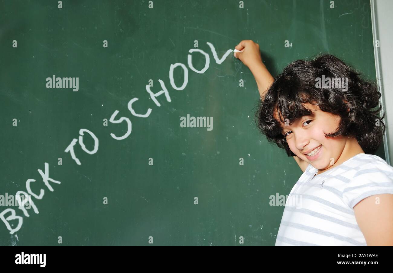 Classroom at school and text on green board Stock Photo - Alamy