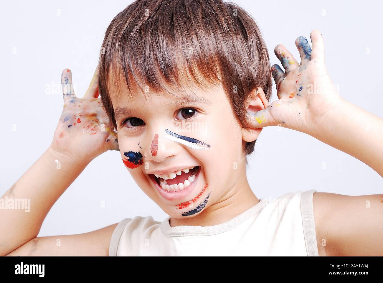Little cute kid with colors on his face Stock Photo - Alamy