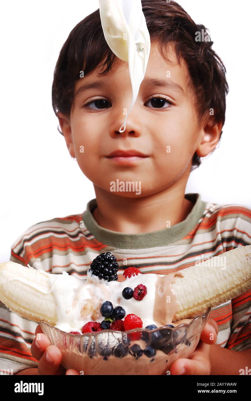 Very cute kid is about to eat very sweet mixed fruint and cream Stock ...