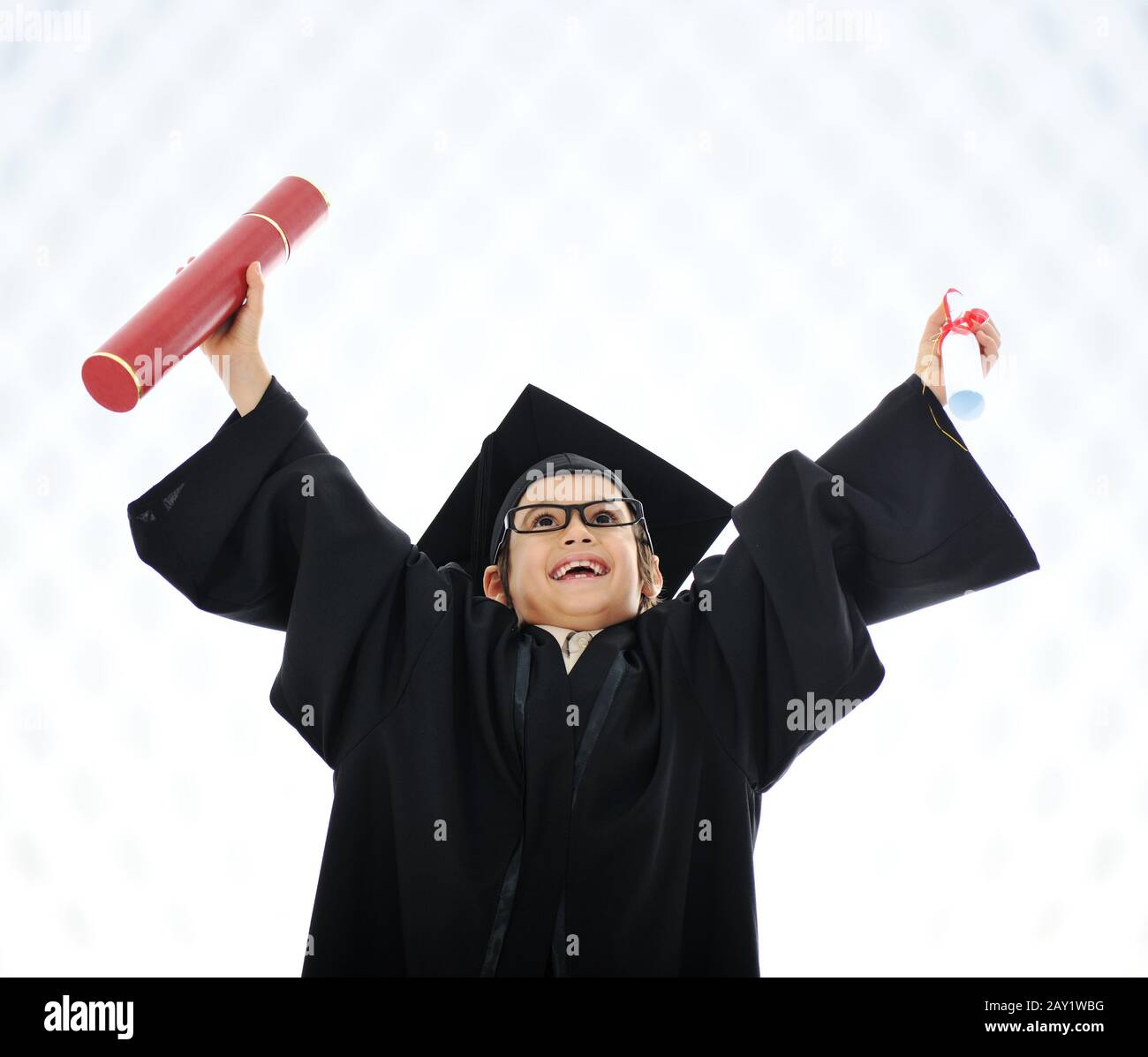 Kid celebrating graduating diploma Stock Photo - Alamy