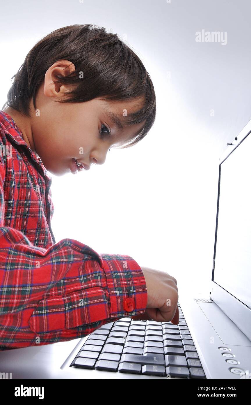 Cute kid sitting with laptop Stock Photo - Alamy