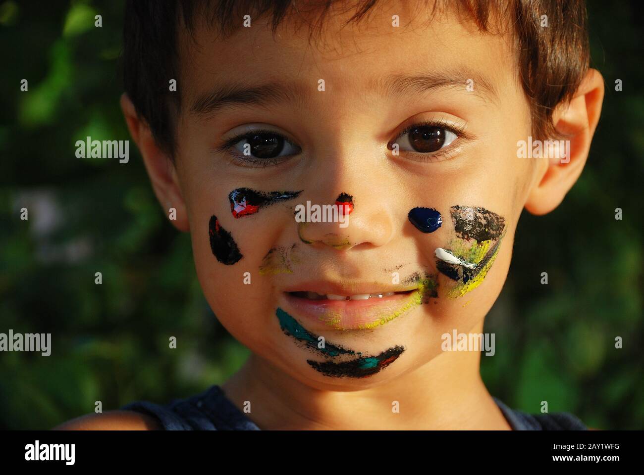 Little cute kid with colors on his face Stock Photo - Alamy