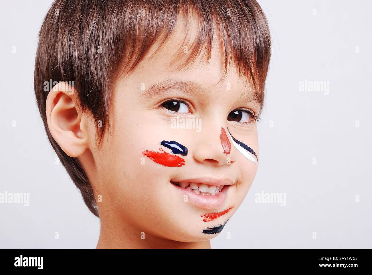 Little cute kid with colors on his face Stock Photo - Alamy