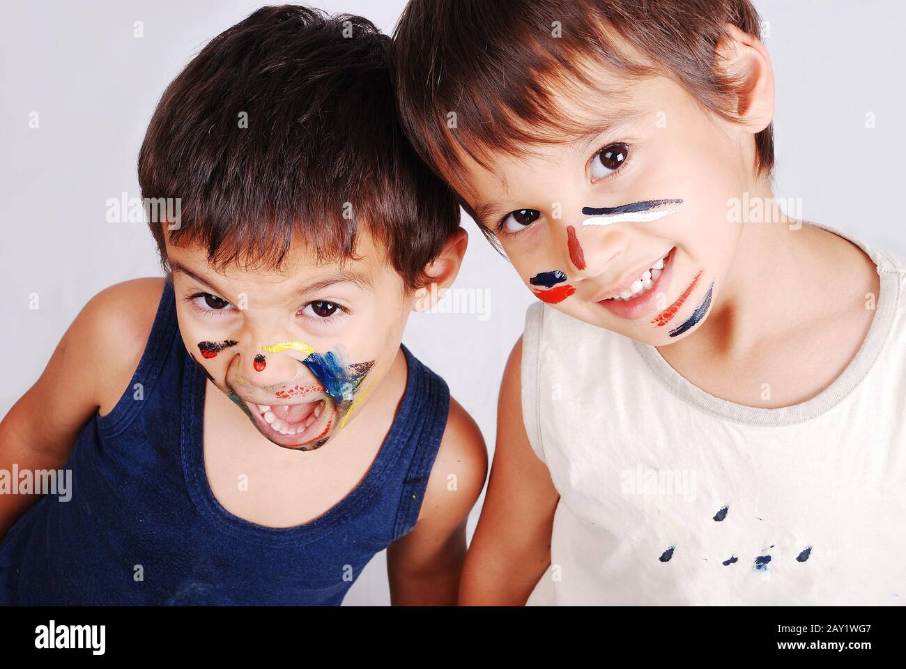 Two little cute brothers with colors on their faces Stock Photo - Alamy