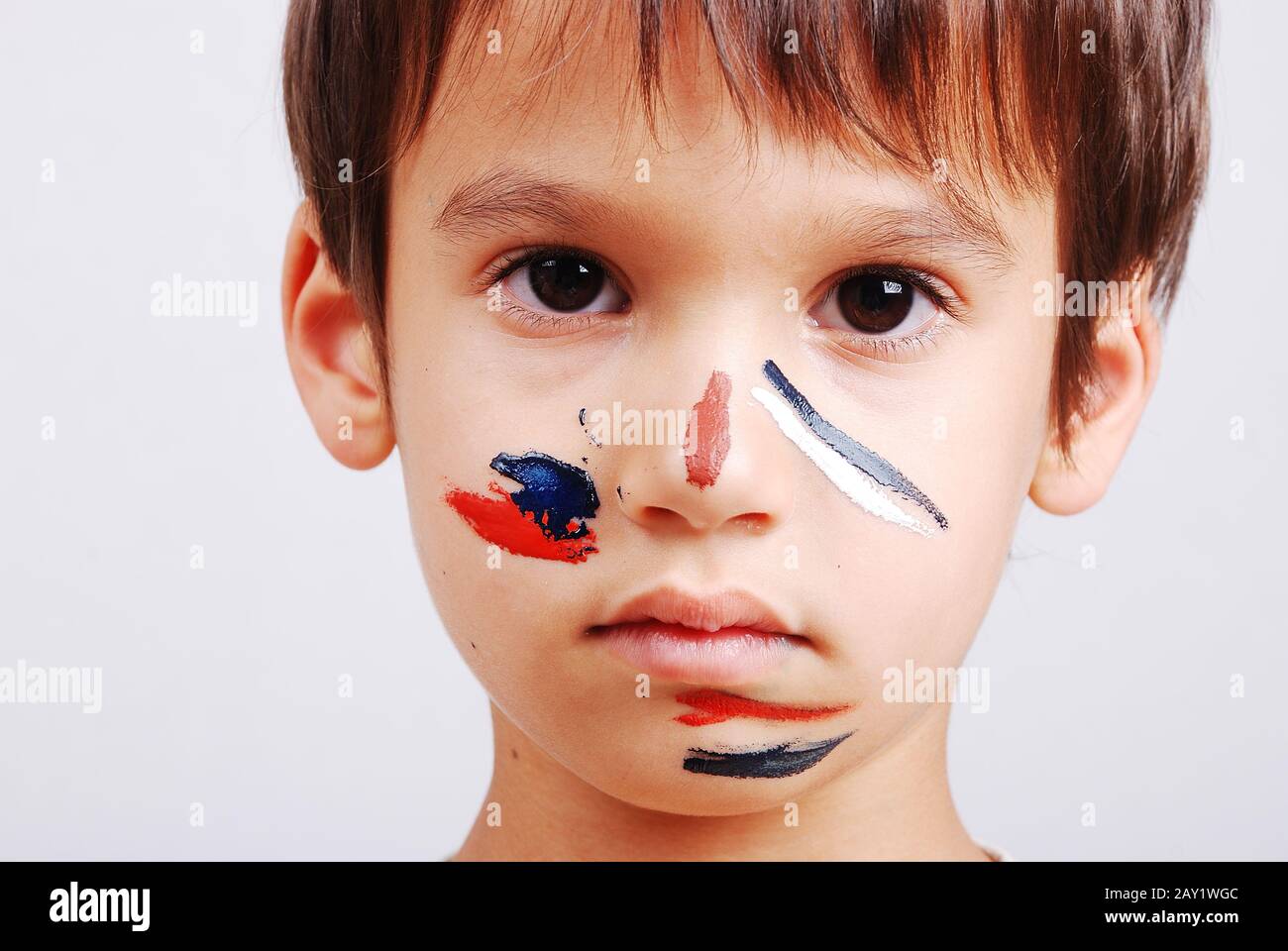 Little cute kid with colors on his face Stock Photo - Alamy