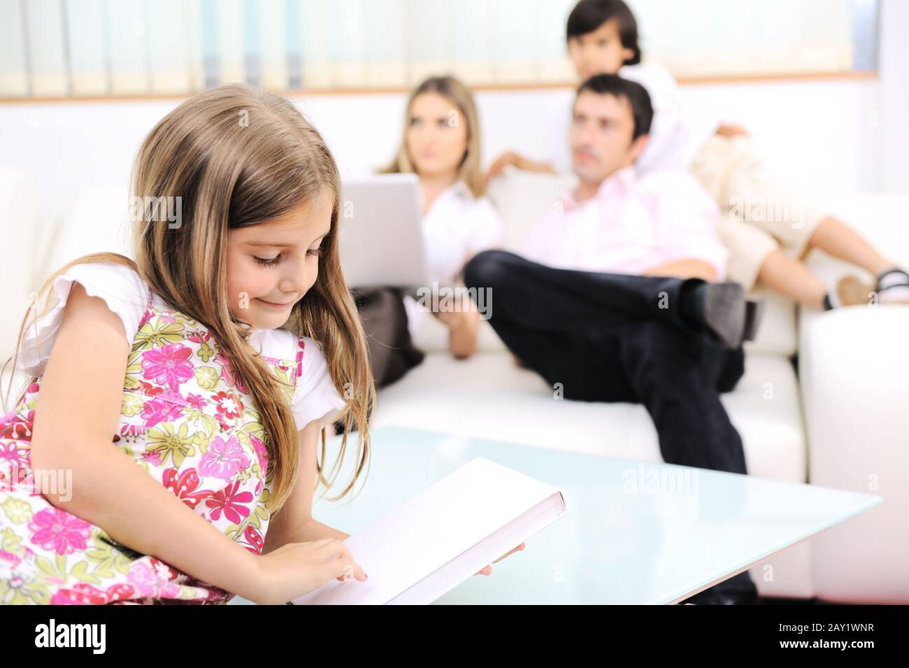 Little girl reading in home Stock Photo - Alamy