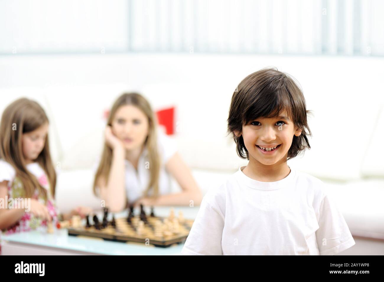 Kid at home with family Stock Photo - Alamy