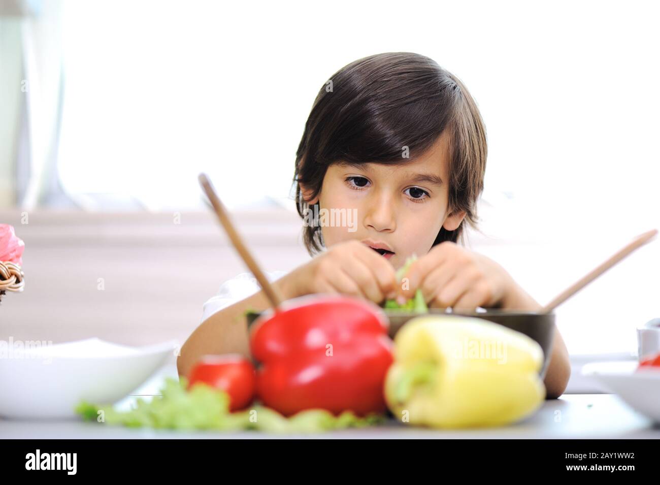 Little boy alone cooking in the kitchen Stock Photo - Alamy