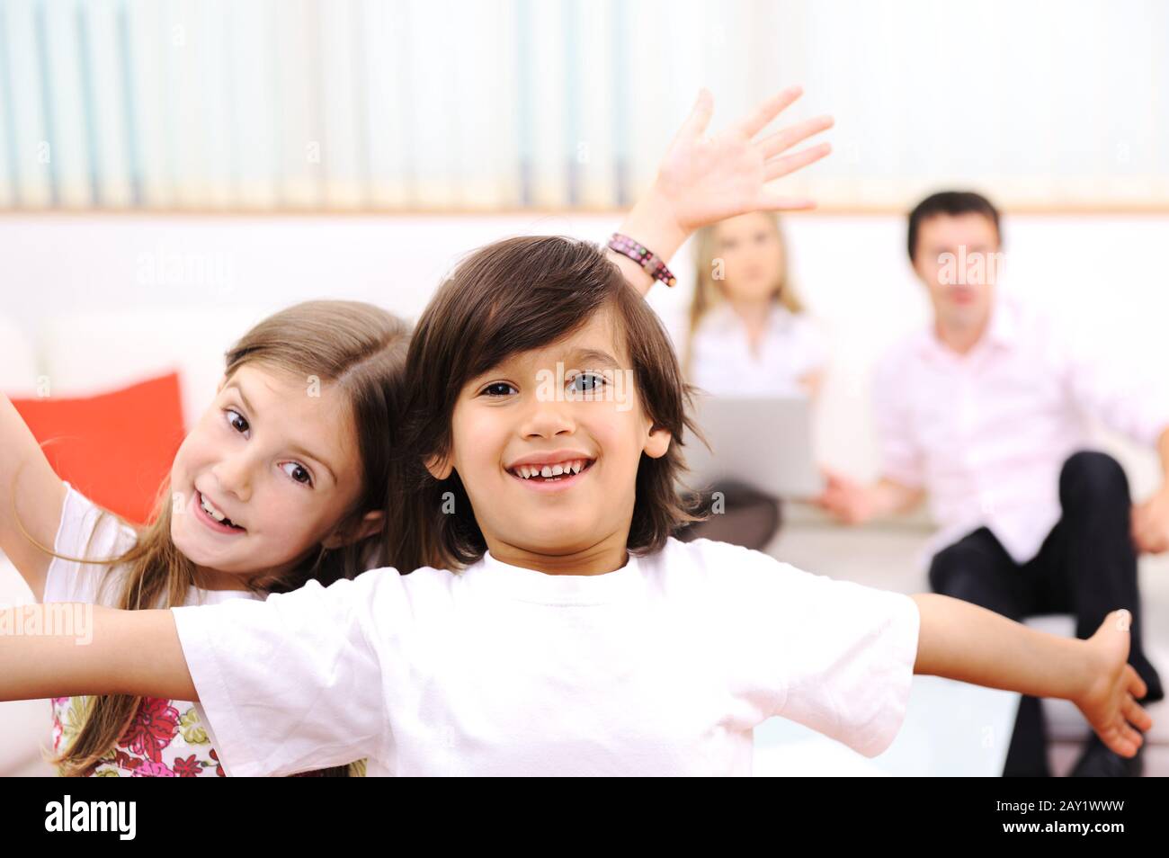 Happy child at home with family Stock Photo - Alamy