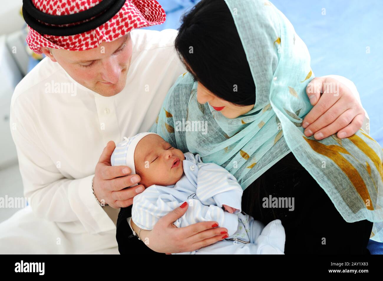 Arabic Muslim couple with new baby at home Stock Photo - Alamy
