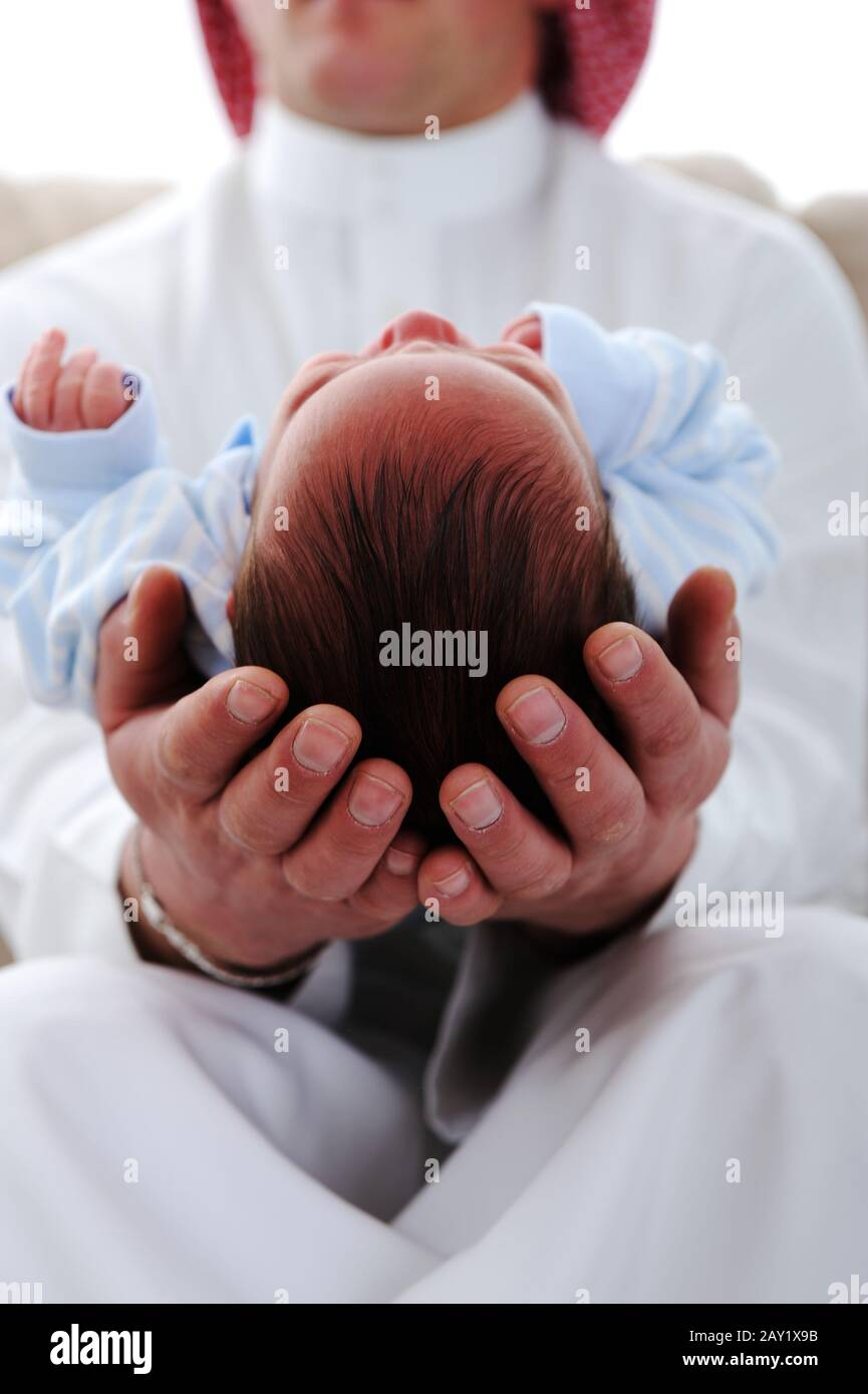 Arabic man holding a newborn baby Stock Photo - Alamy