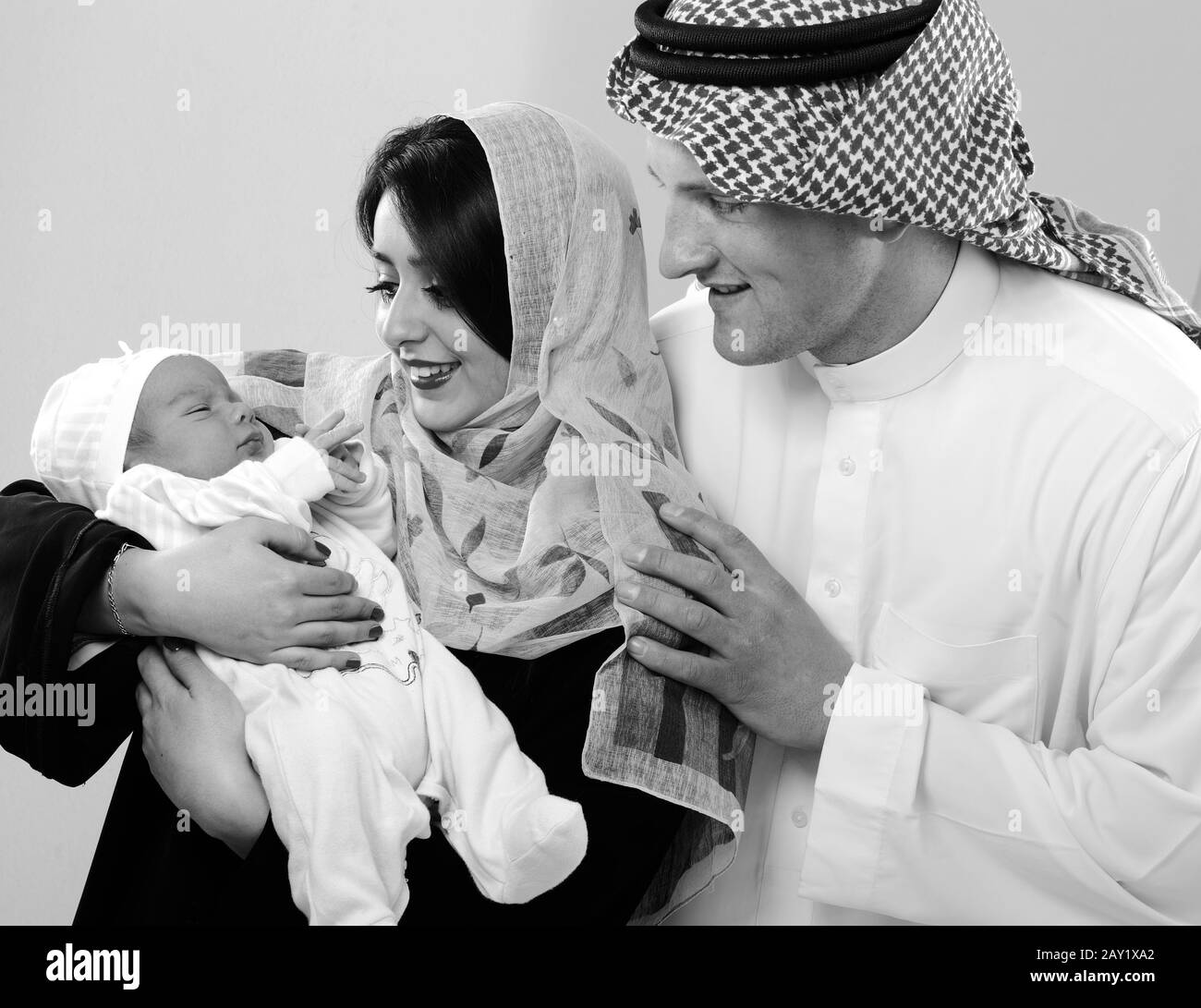 Arabic Muslim couple with new baby at home Stock Photo - Alamy
