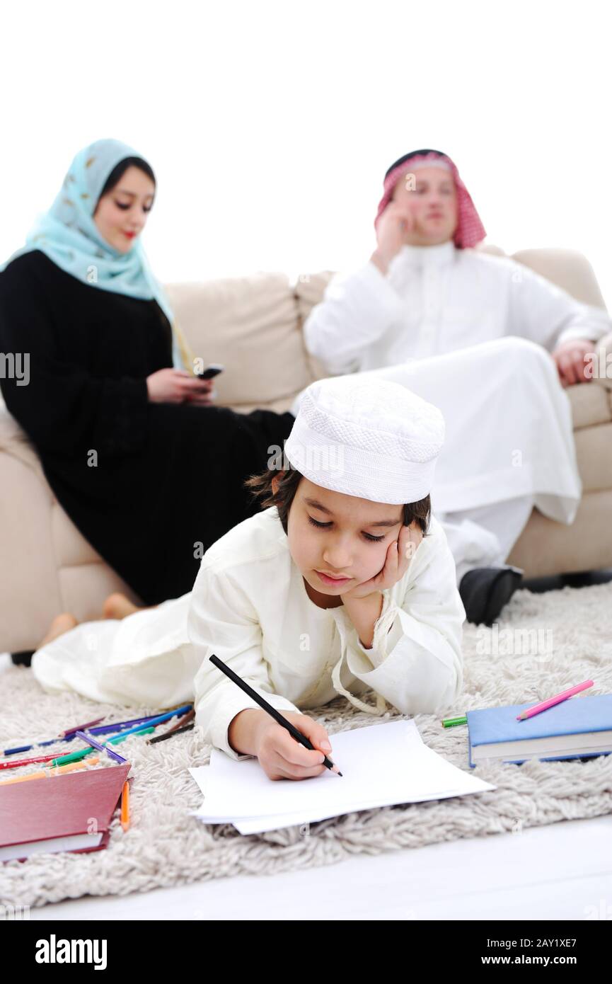 Happy child working on homework at home with his family Stock Photo - Alamy