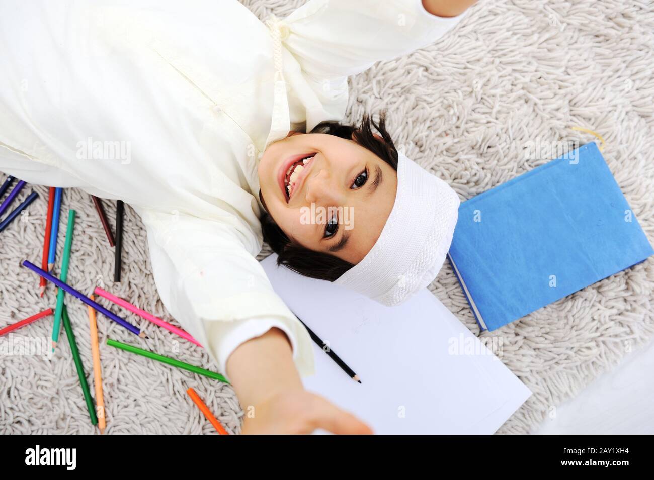 Arabian Muslim kid doing homework at home Stock Photo - Alamy
