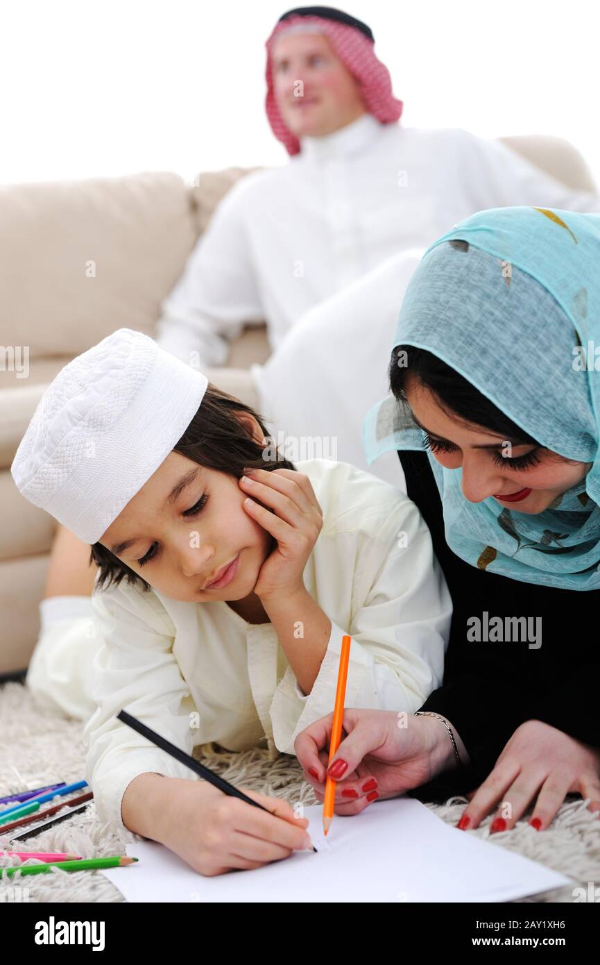Happy child working on homework at home with his family Stock Photo - Alamy