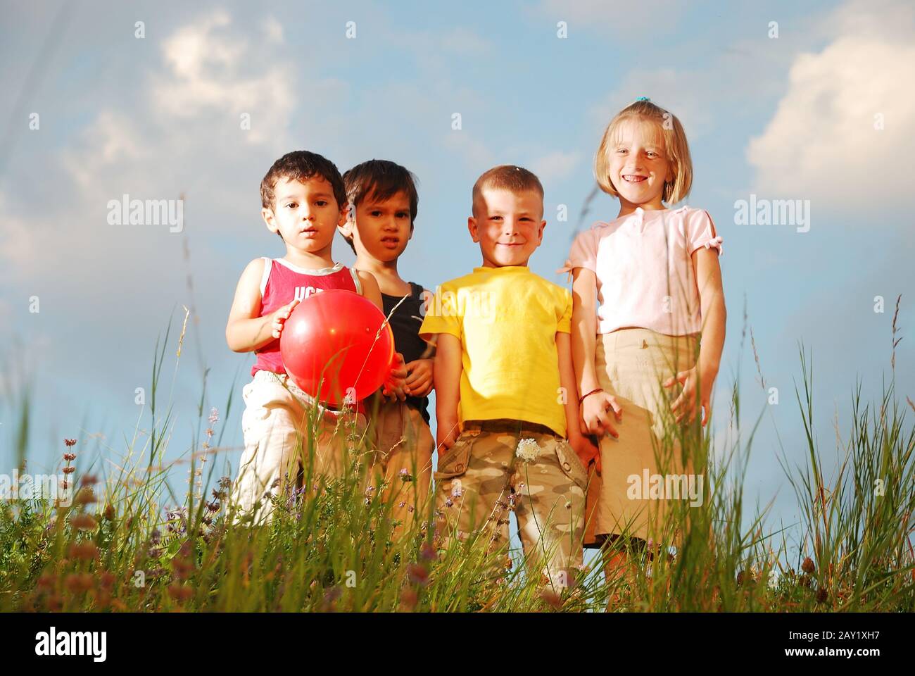 Children sit together on field hi-res stock photography and images - Alamy