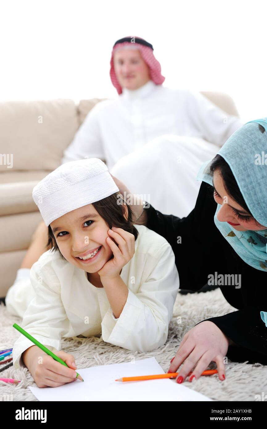 Happy child working on homework at home with his family Stock Photo - Alamy