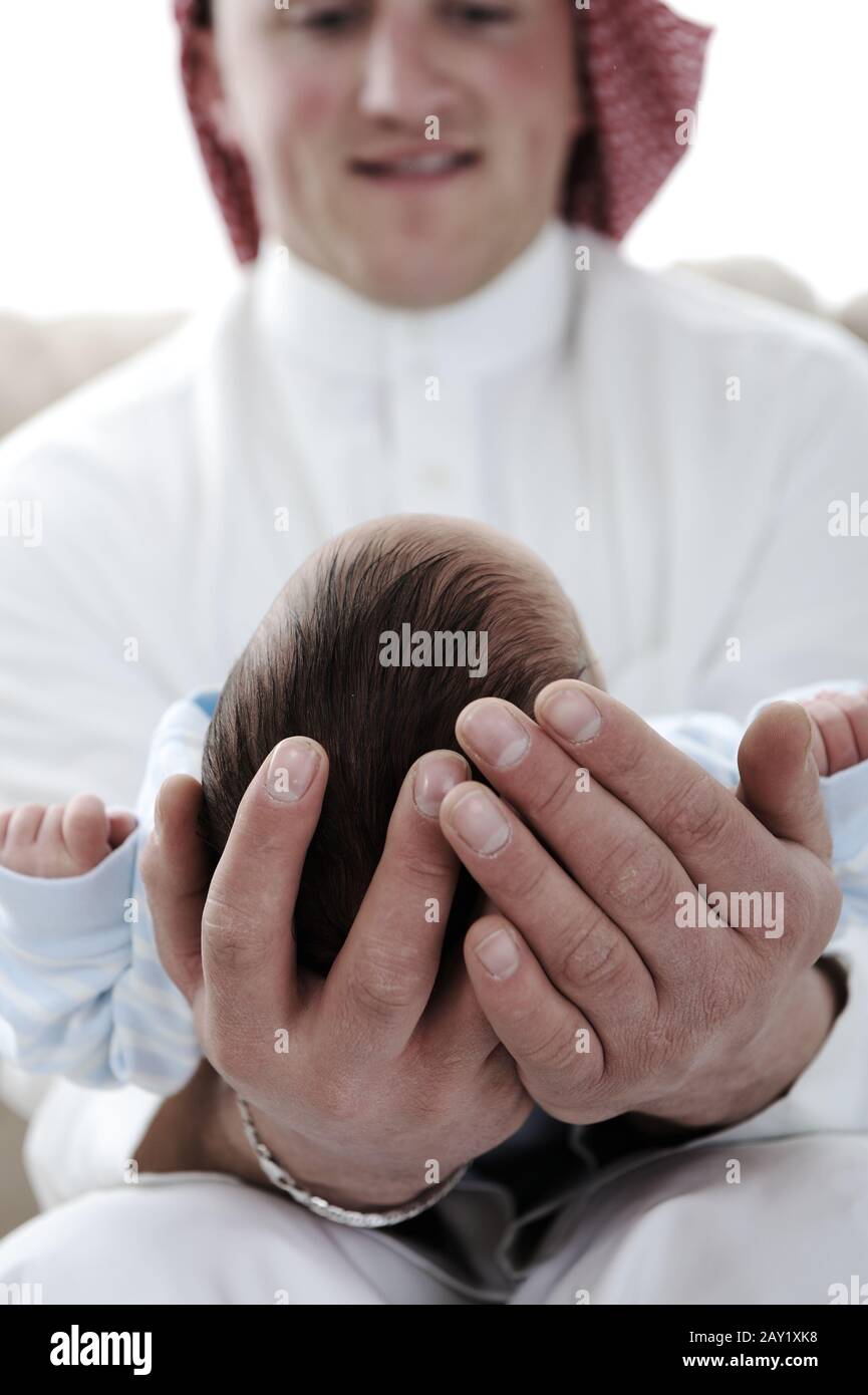 Arabic man holding a newborn baby Stock Photo - Alamy