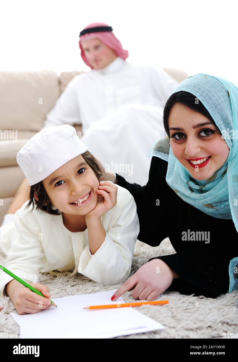 Happy child working on homework at home with his family Stock Photo - Alamy