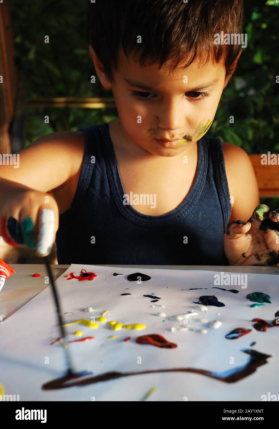 Little cute kid is painting with colors Stock Photo - Alamy