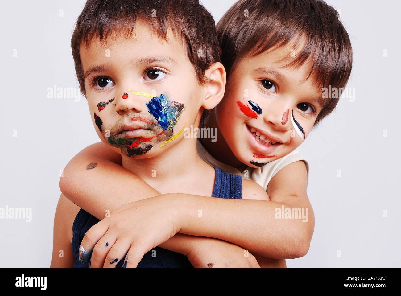 Two little cute brothers with colors on their faces Stock Photo - Alamy