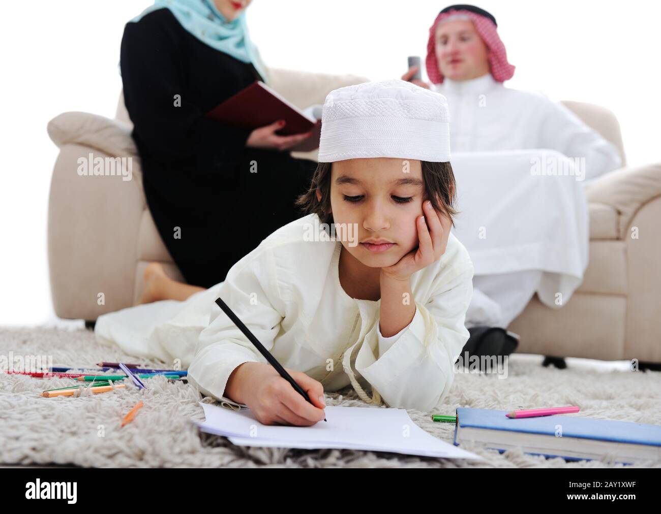 Happy child working on homework at home with his family Stock Photo - Alamy