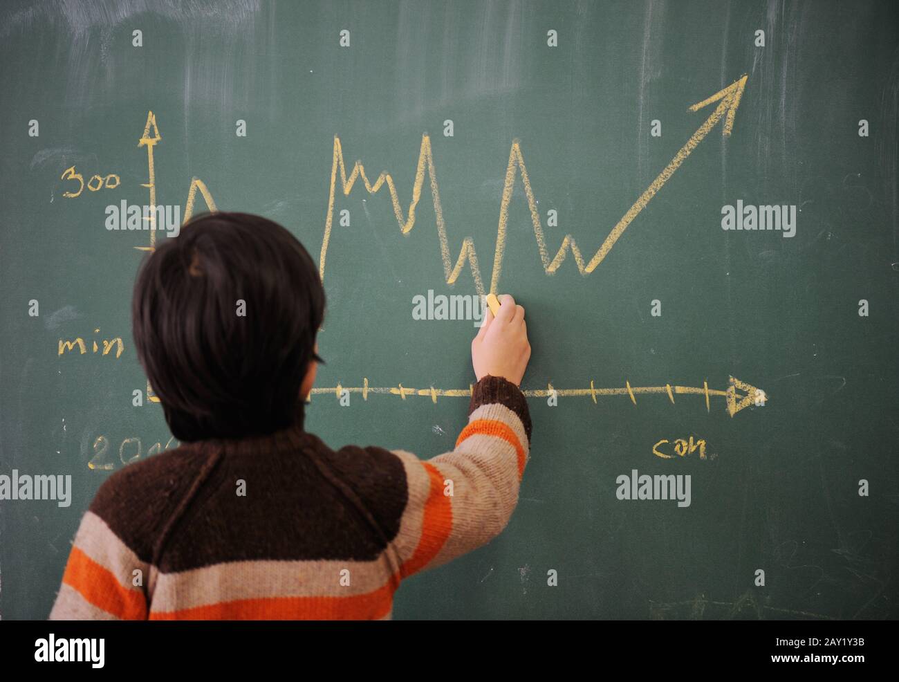 Kid writing diagram on blackboard Stock Photo - Alamy