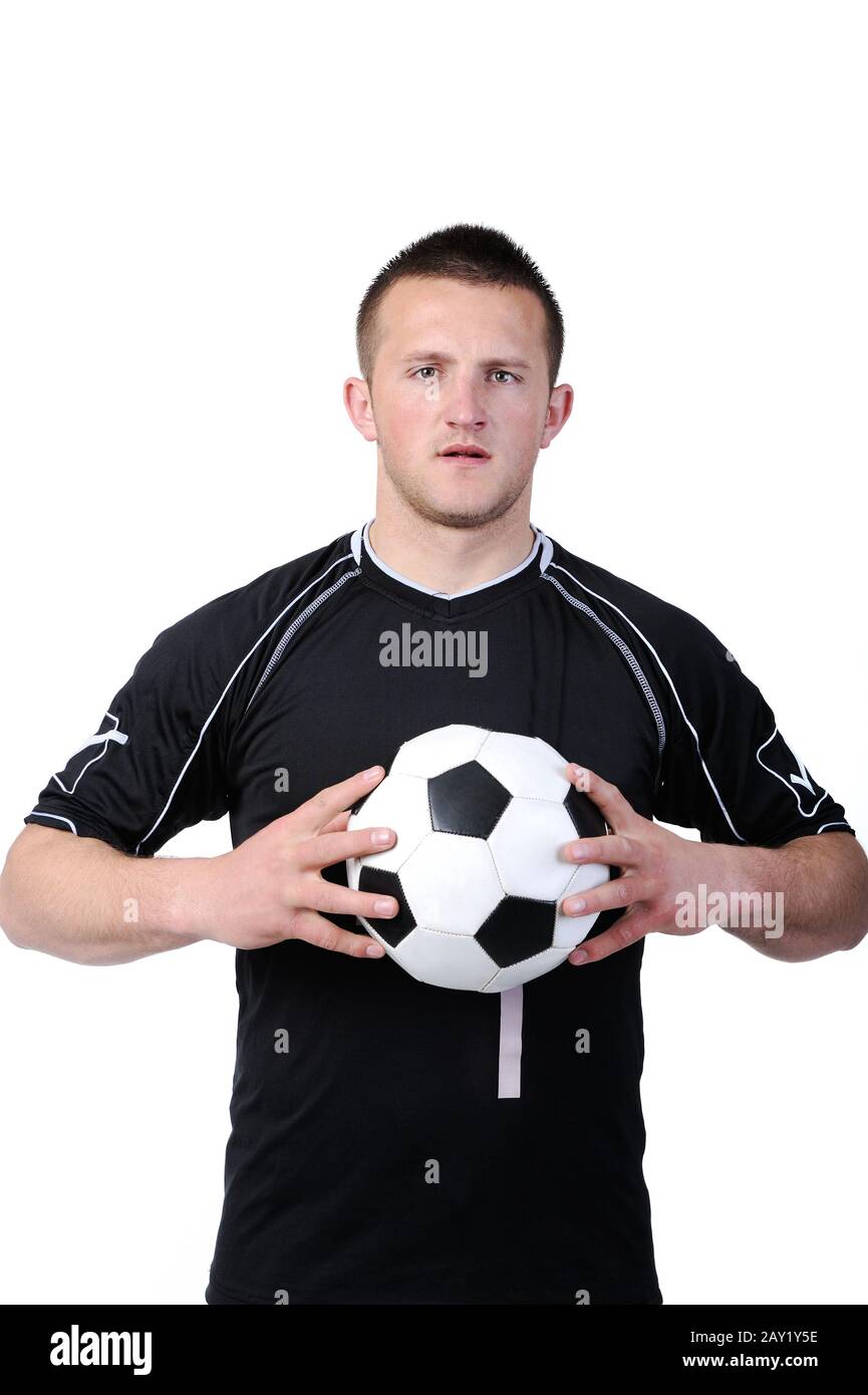 Soccer player holding a football isolated on white background Stock ...