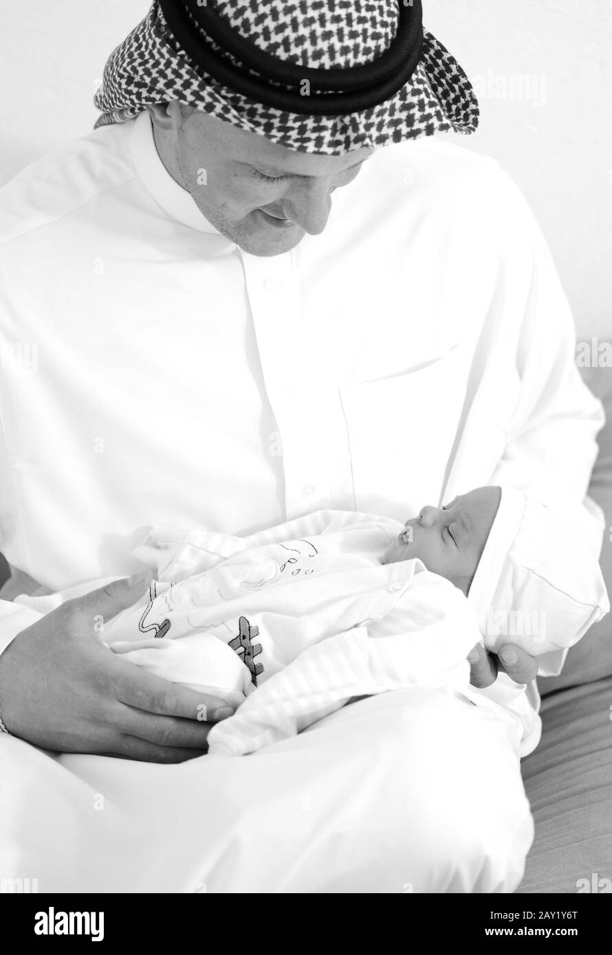 Arabic man holding a newborn baby Stock Photo - Alamy