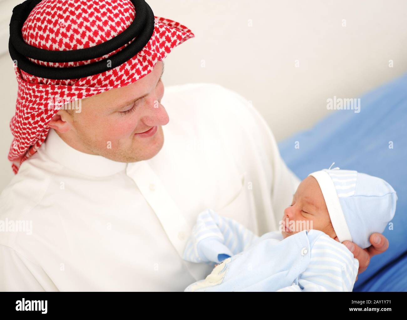 Arabic man holding a newborn baby Stock Photo - Alamy