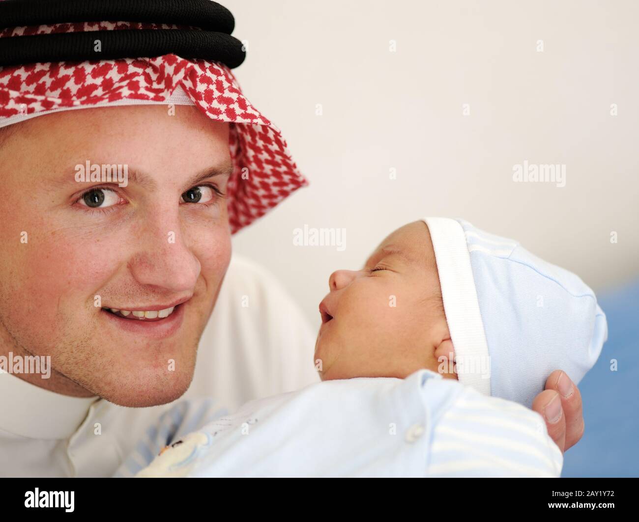 Arabic man holding a newborn baby Stock Photo - Alamy