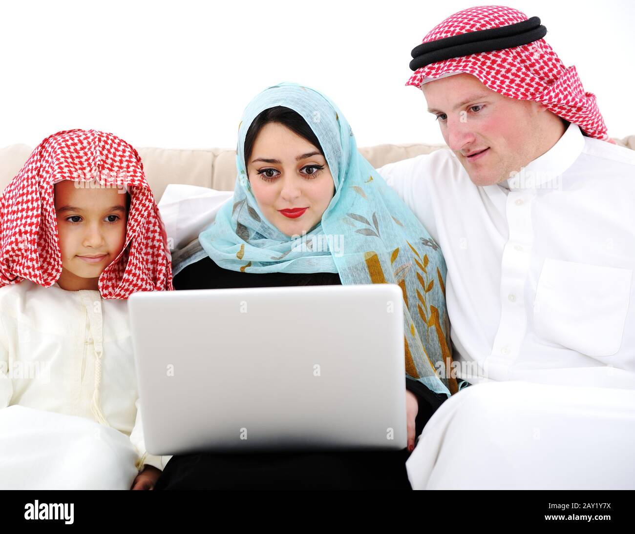 Arabic parents and little boy at home with laptop computer Stock Photo ...
